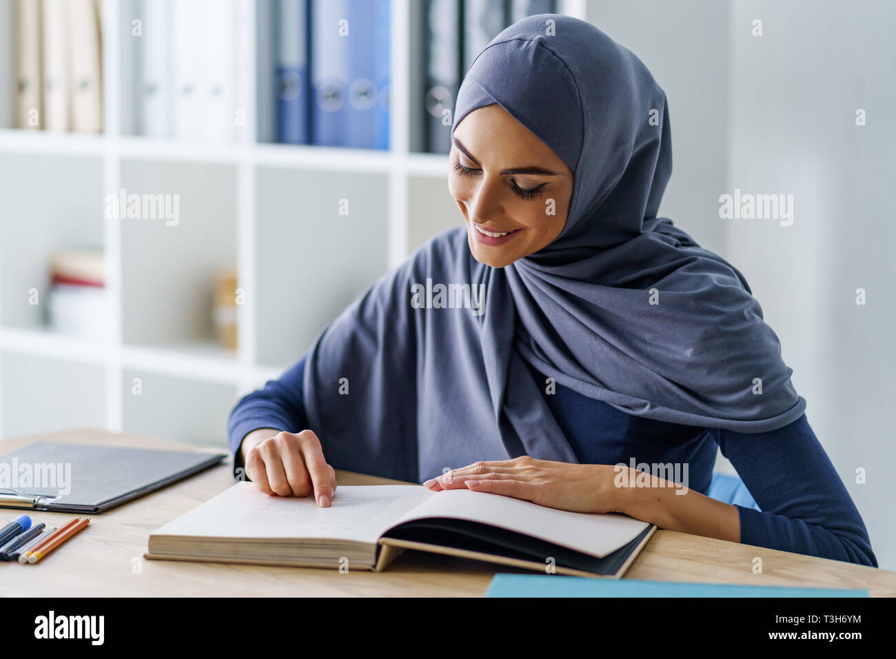 Muslim arabic female reading book hi-res stock photography and images ...