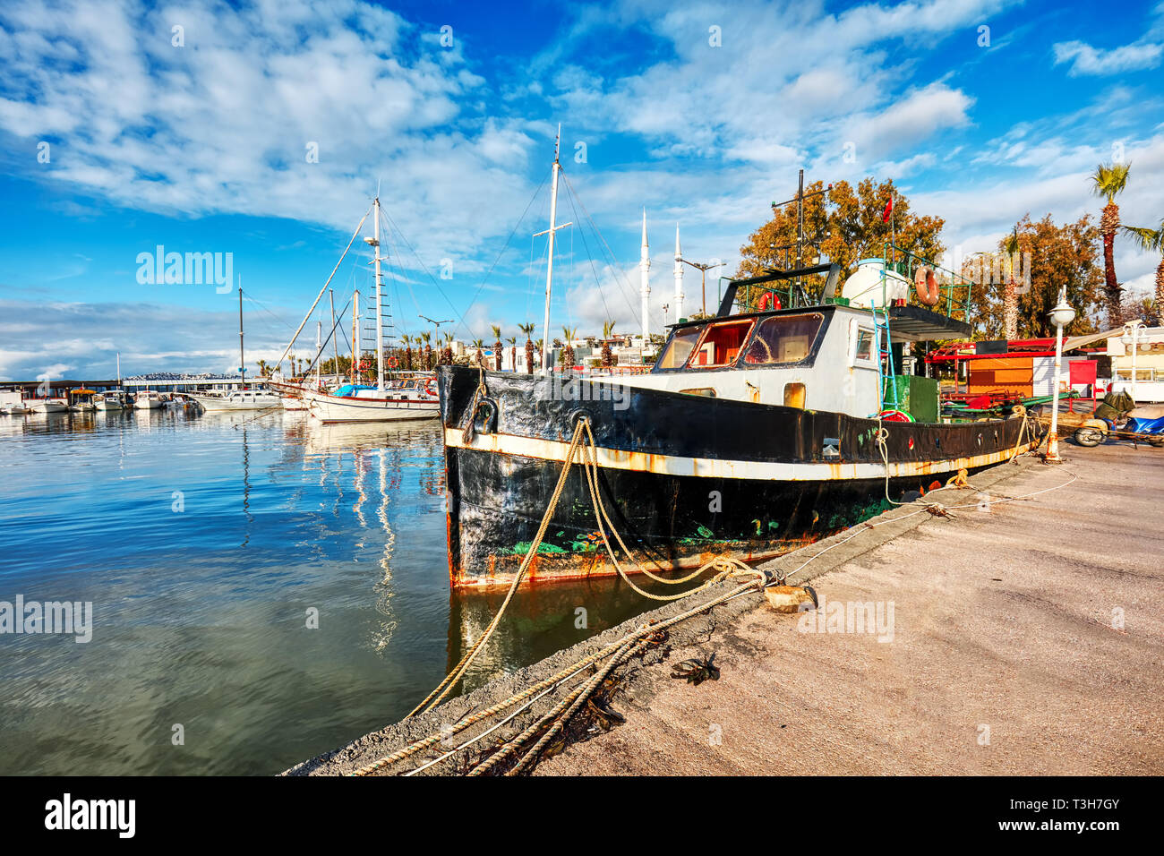 Old vintage rusty fishing boat anchored in Turgutreis harbor in Bodrum ...