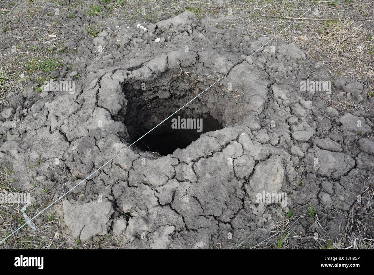 Digging hole for fence concrete foundation holder Stock Photo - Alamy