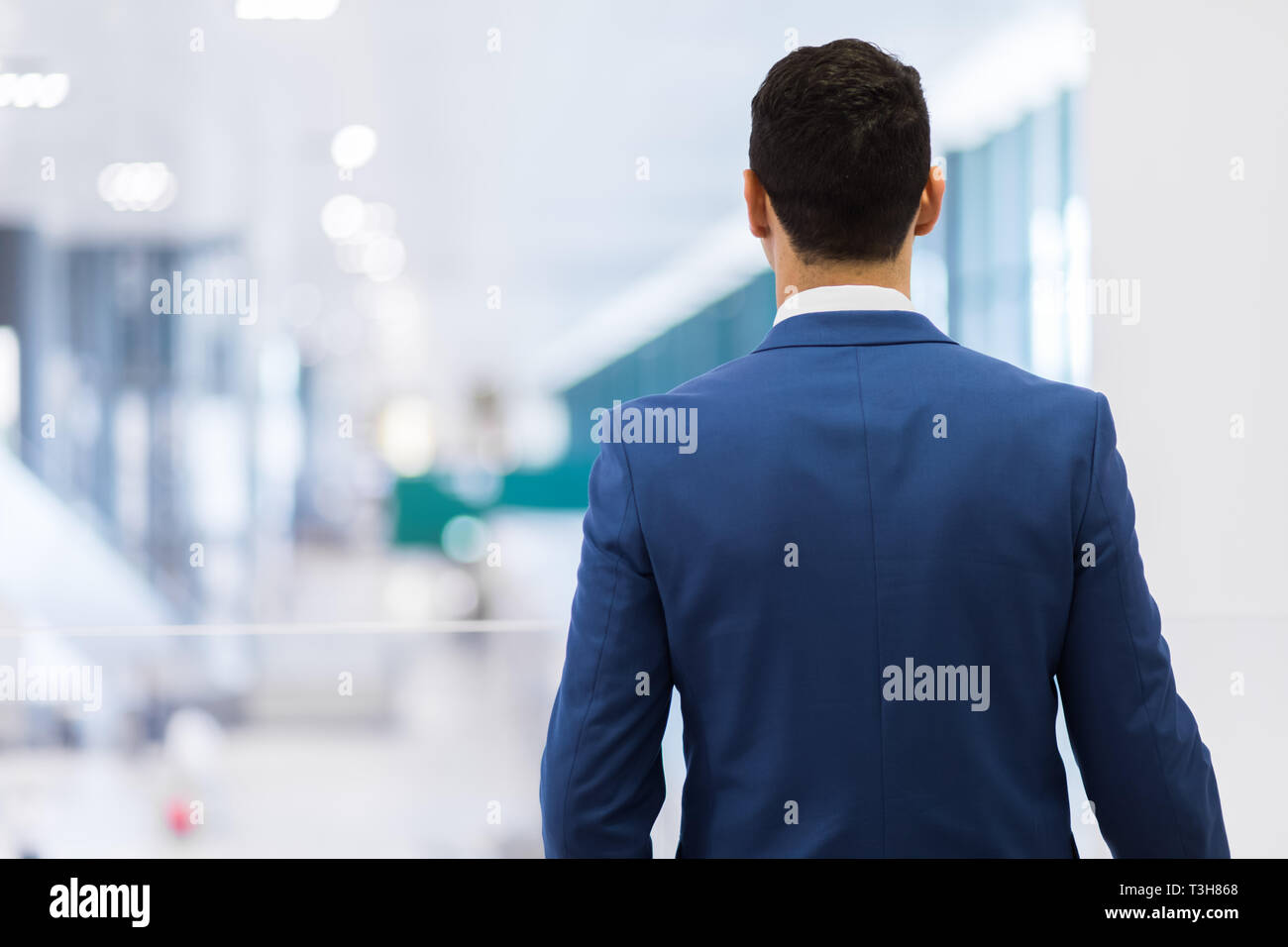 Back view of a manager walking Stock Photo - Alamy