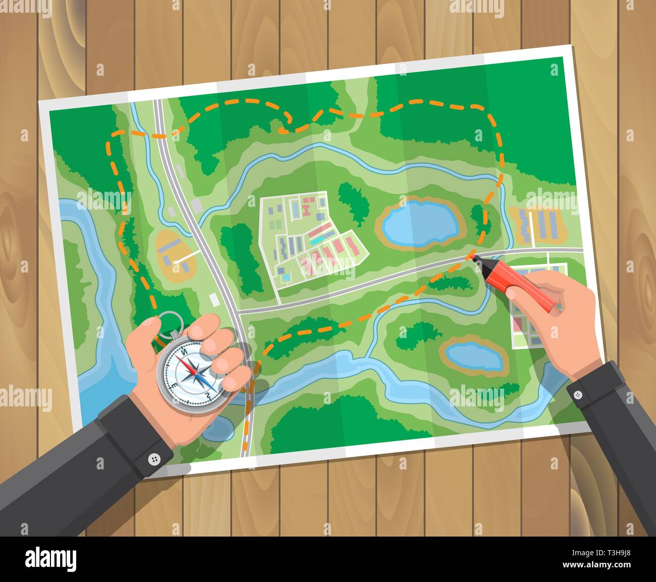 Wooden table with paper map and compass. Marker in hands. Planning trip ...