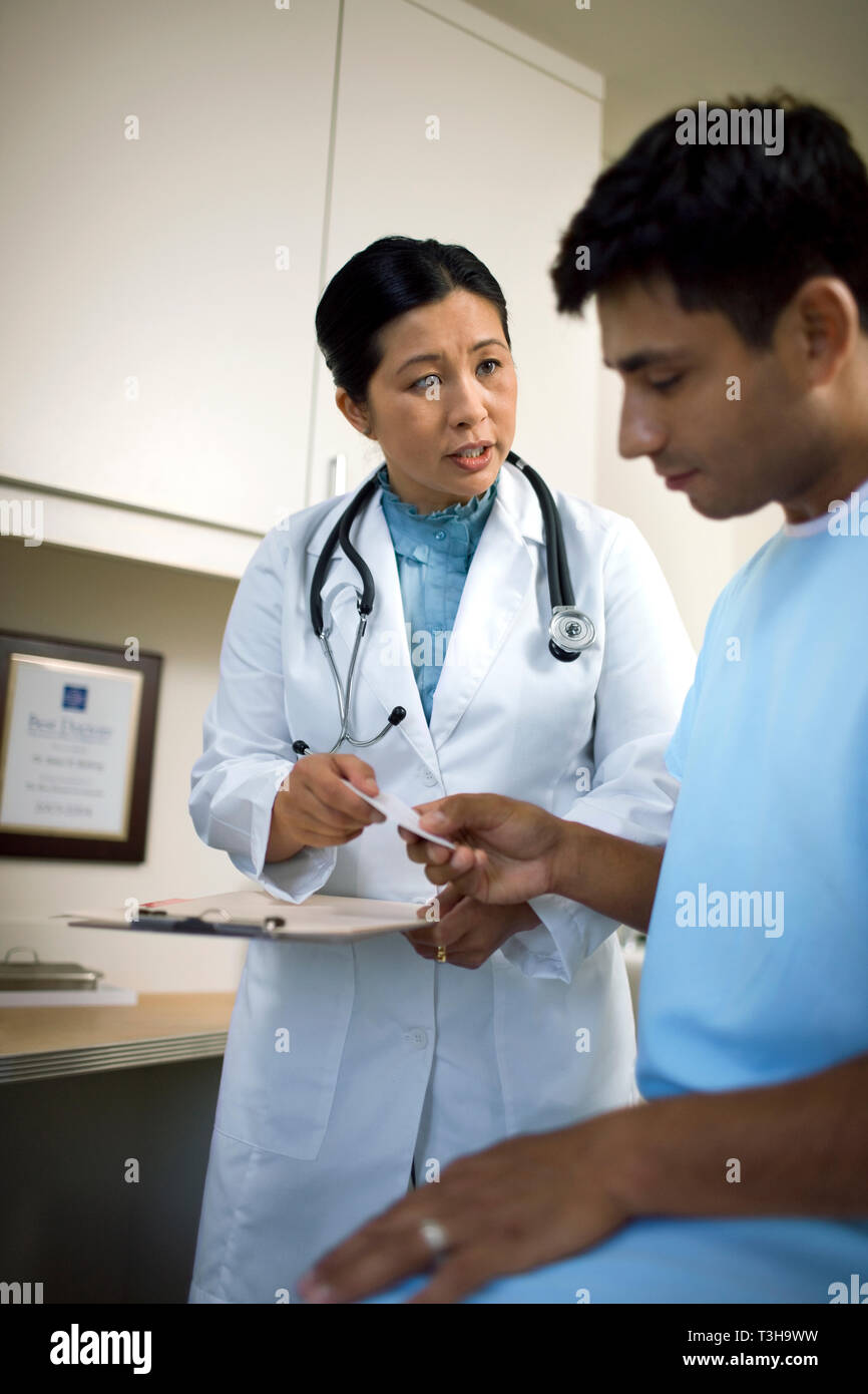 Female doctor consulting with a patient after a medical examination in ...