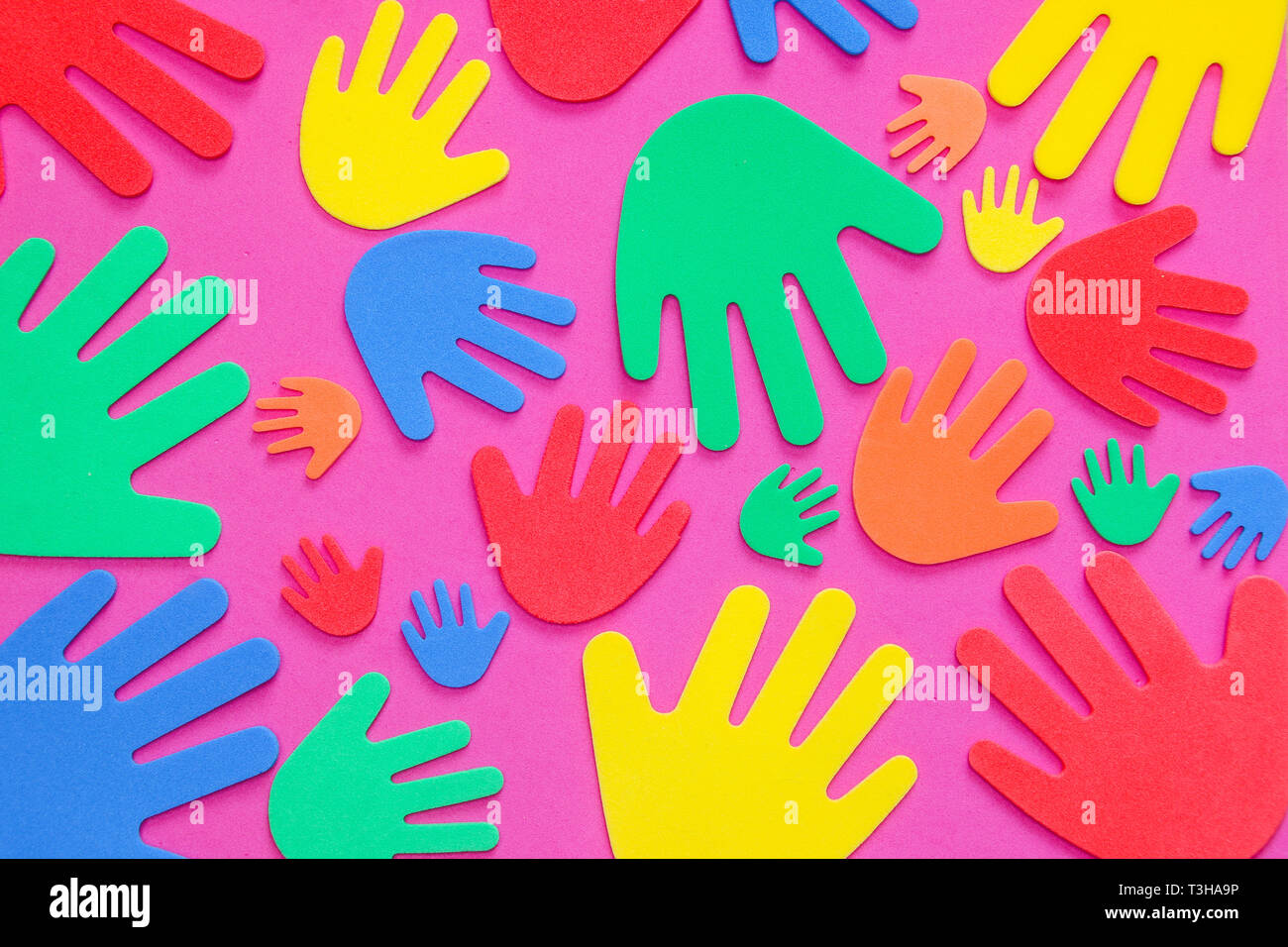Brightly colored foam hand shapes of green, orange, red, yellow and ...