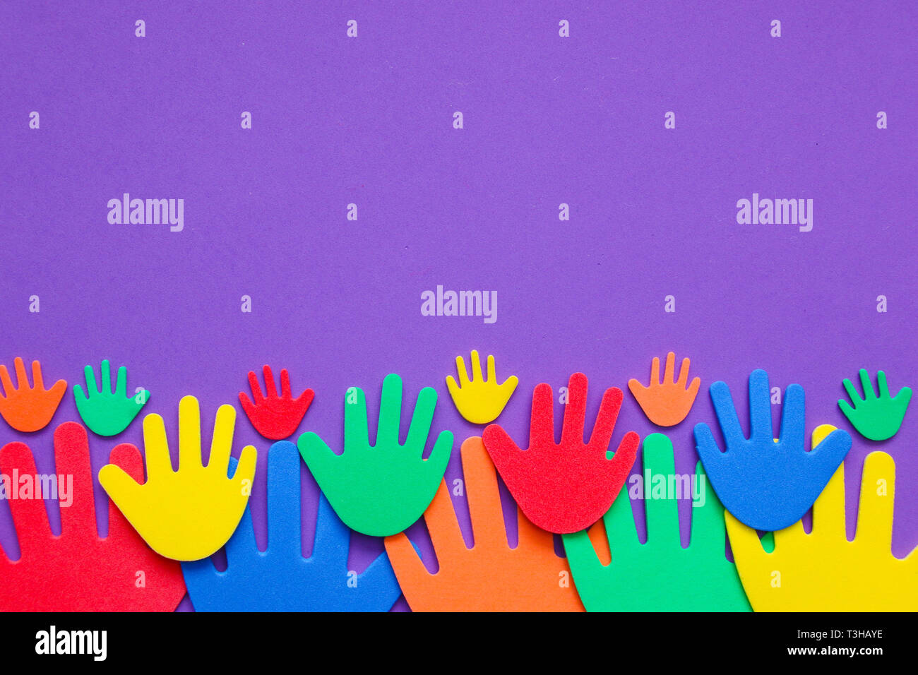 Brightly colored foam hand shapes of green, orange, red, yellow and ...