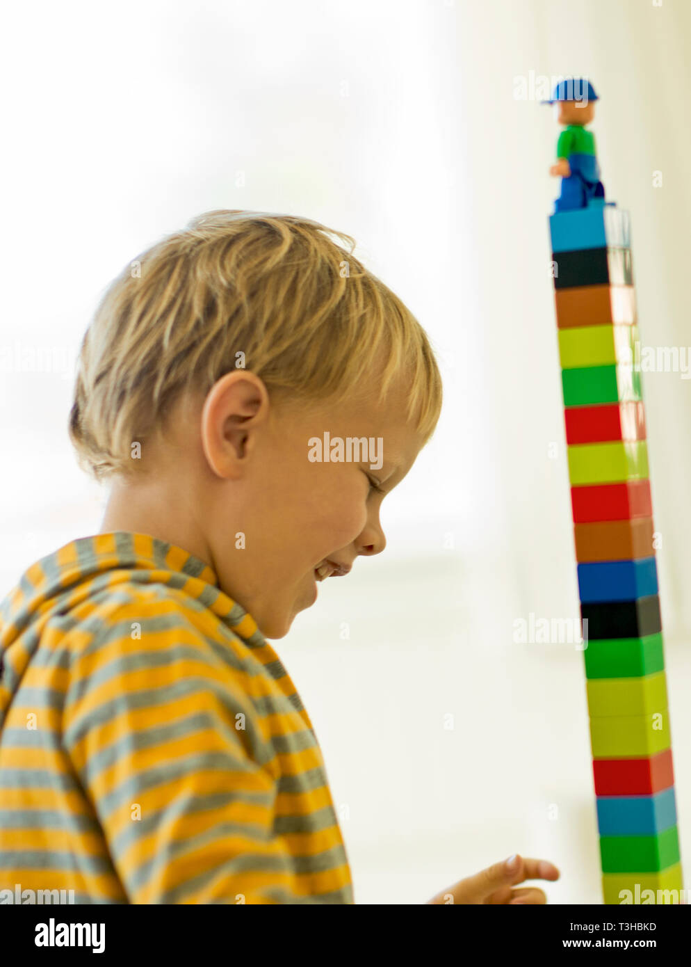 Boy building a big lego stack Stock Photo - Alamy