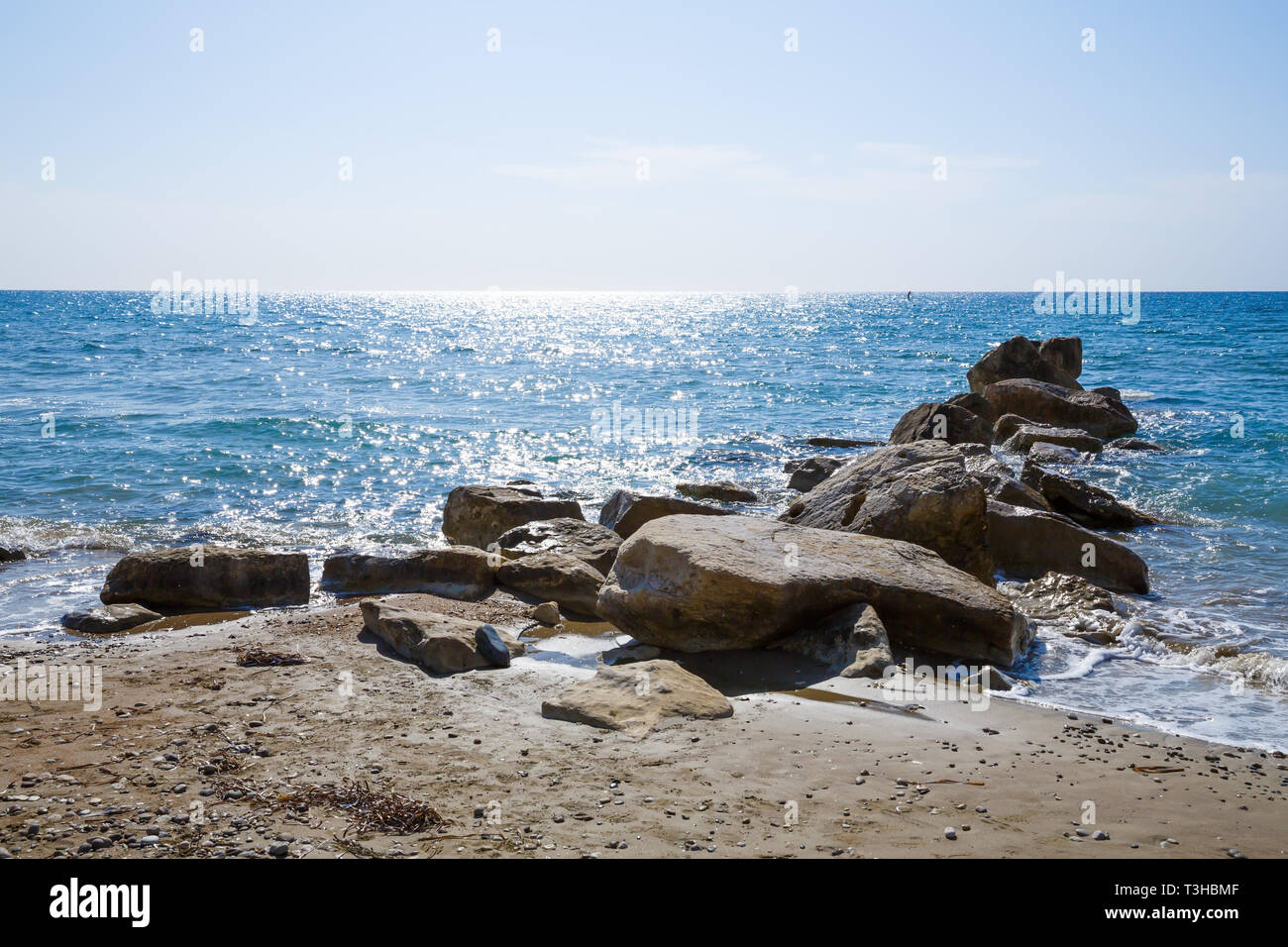 Blue Mediterranean sea with the sparkling surface and stones in Cyprus ...