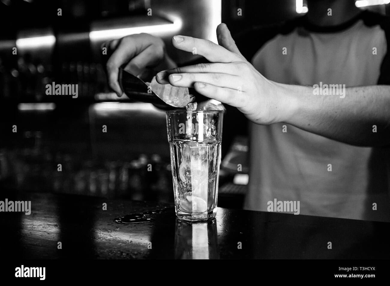 Cocktails by a barmen in a nightclub - Bartender skills are shown Stock Photo - Alamy
