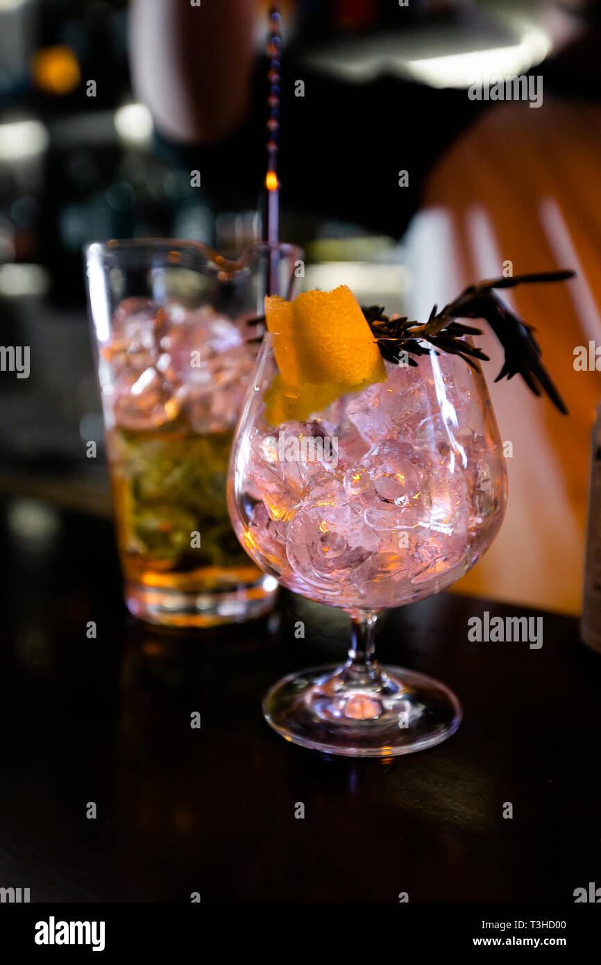 Cocktails by a barmen in a nightclub - Bartender skills are shown Stock ...