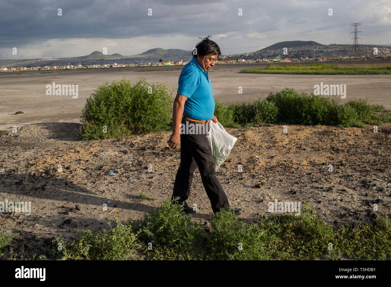 A man walks across an area of land that was once part of Lake Texcoco, in Chimalhuac‡n, the ...