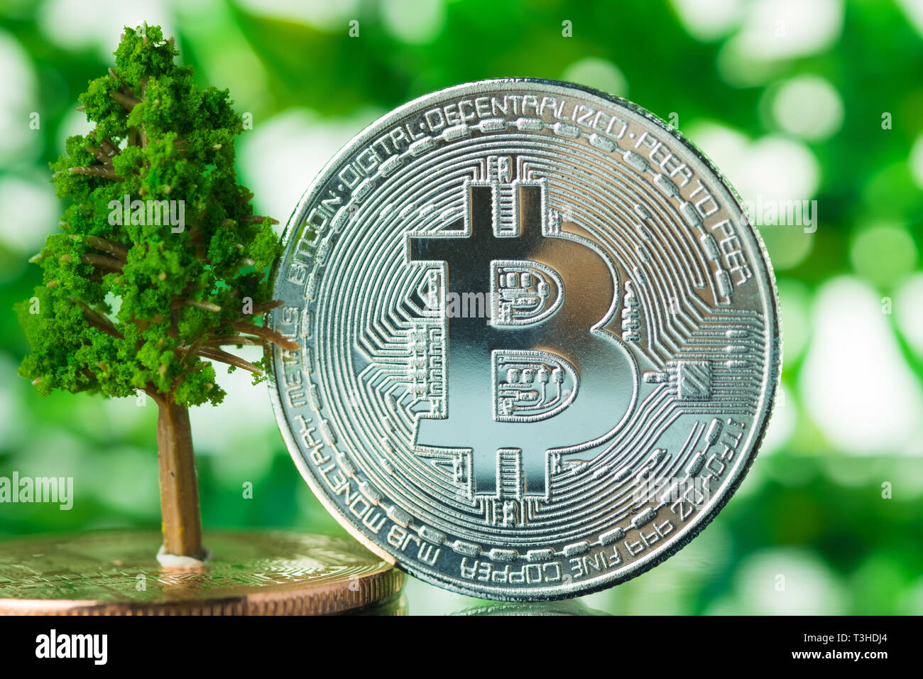 Bitcoin digital currency, bit-coin on green blurred bokeh background, Cryptocurrency money ...