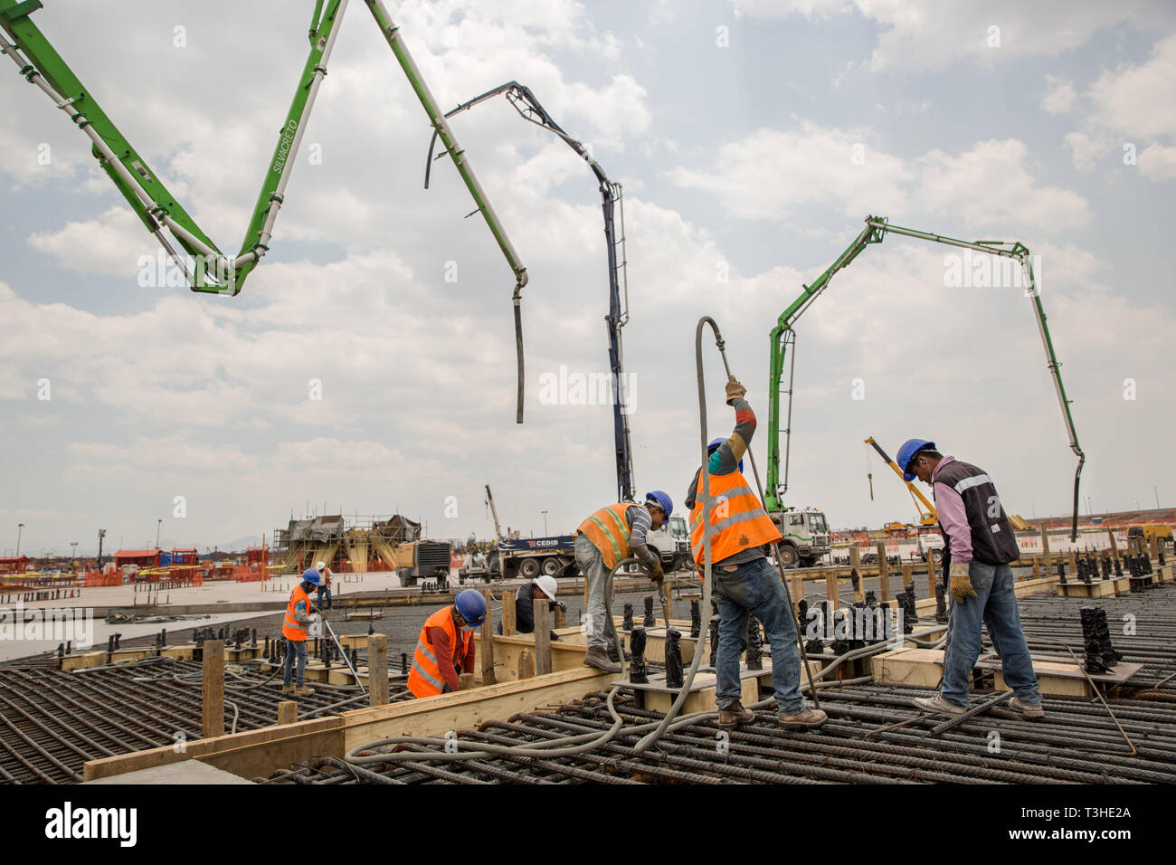 Construction workers build the first terminal of the New International ...