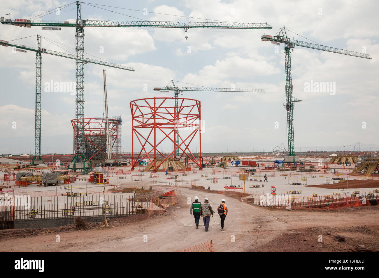 Construction workers build the first terminal of the New International ...