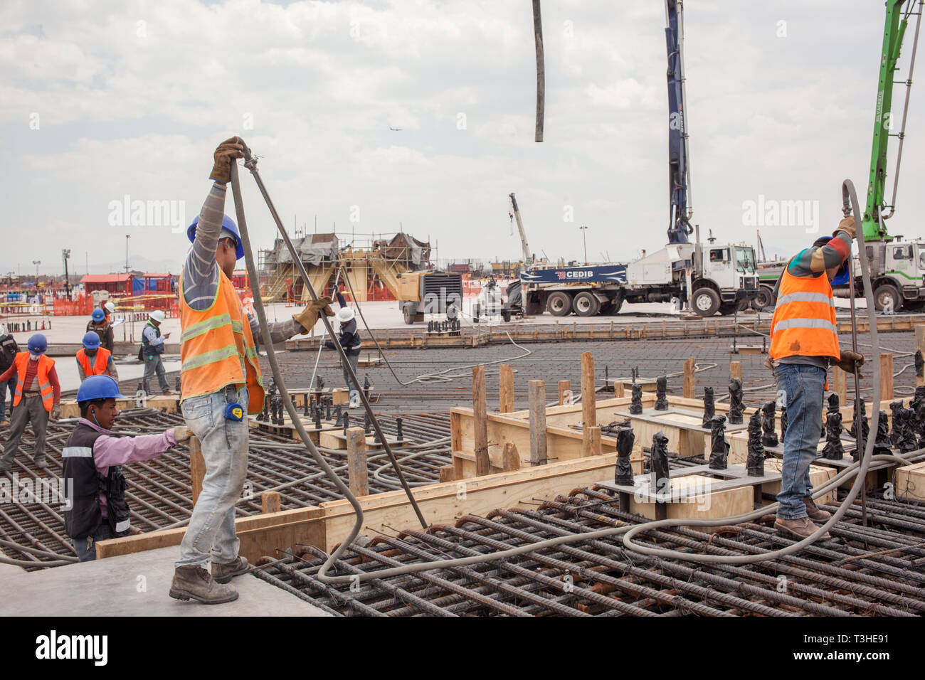 Construction workers build the first terminal of the New International ...