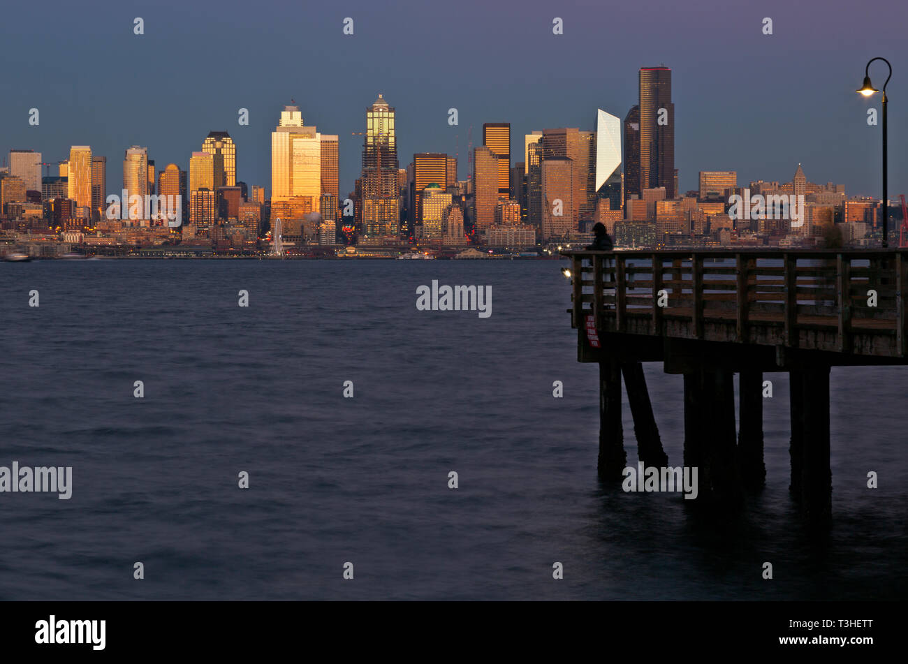 WA16110-00...WASHINGTON - Setting sun creating a glow on downtown ...