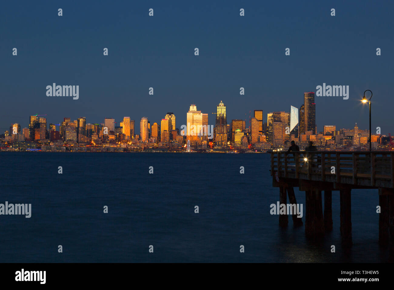 WA16116-00...WASHINGTON - Setting sun creating a glow on downtown ...