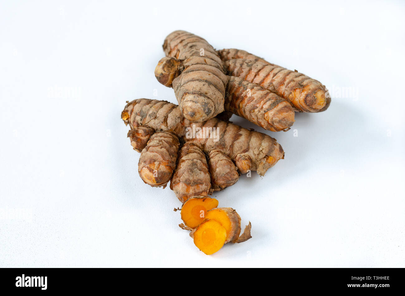 Turmeric root on white background Stock Photo - Alamy