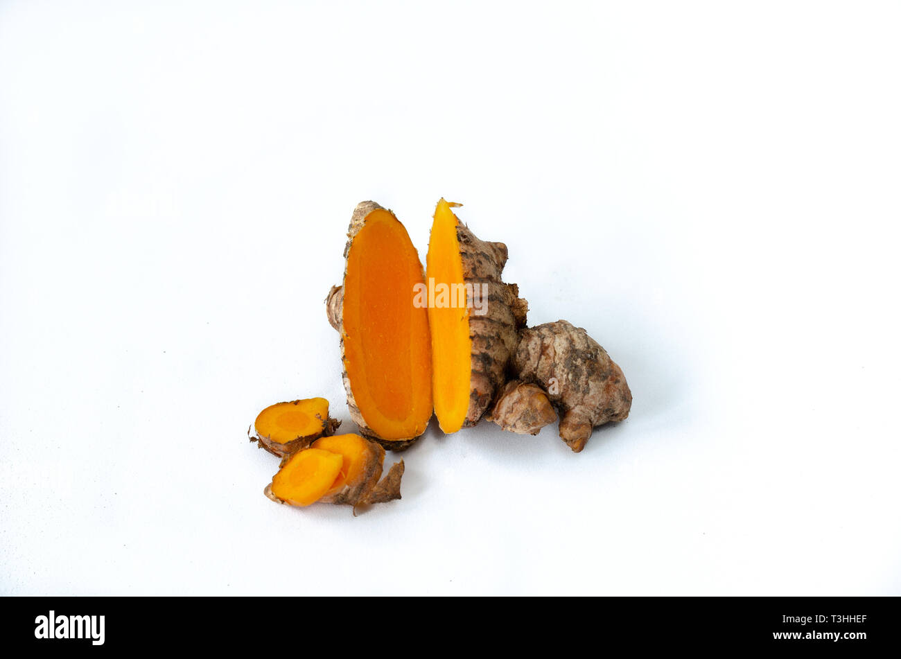 Turmeric sliced on white background Stock Photo - Alamy
