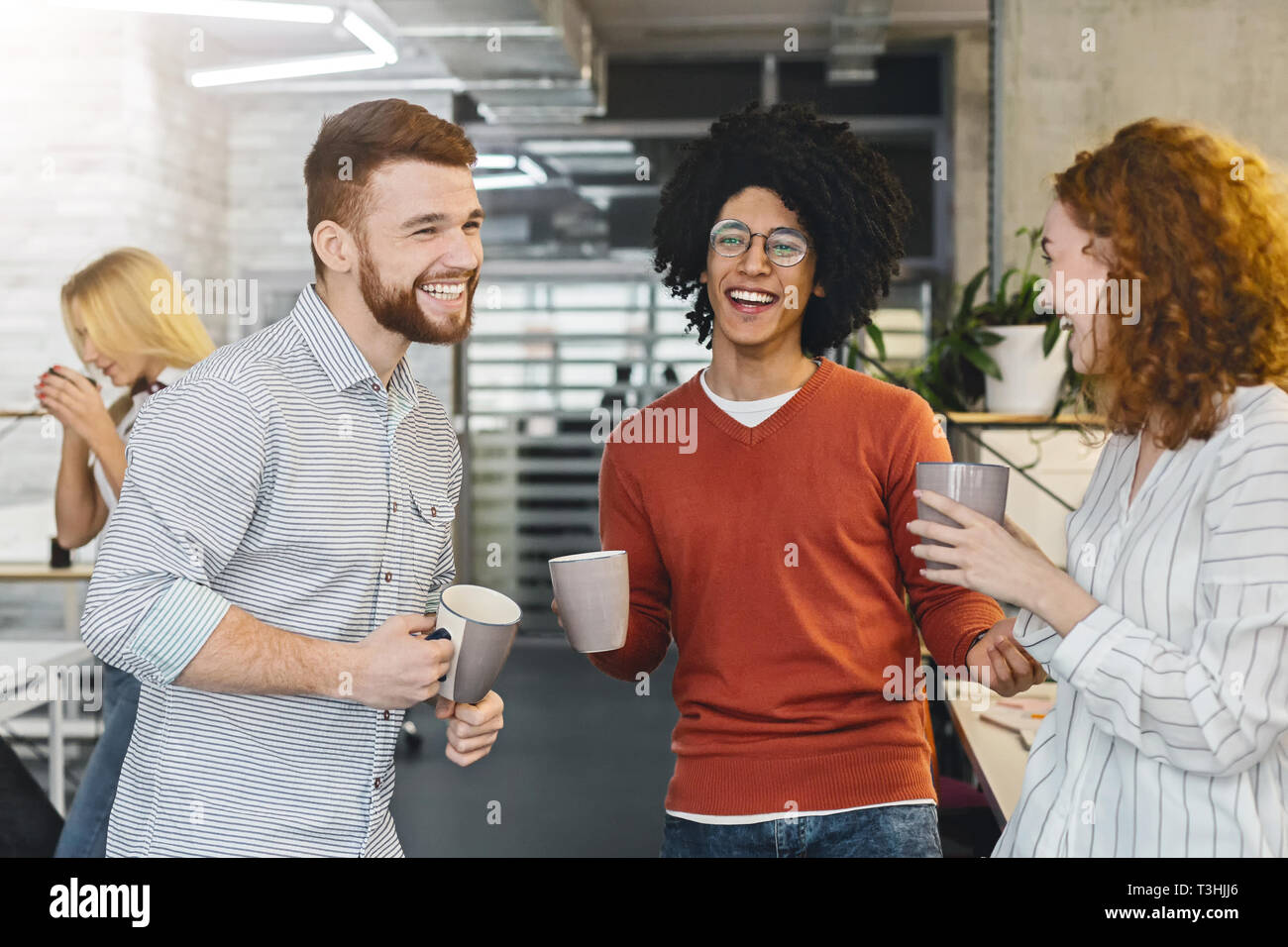 Group of millennial coworkers drinking coffee and talking Stock Photo ...