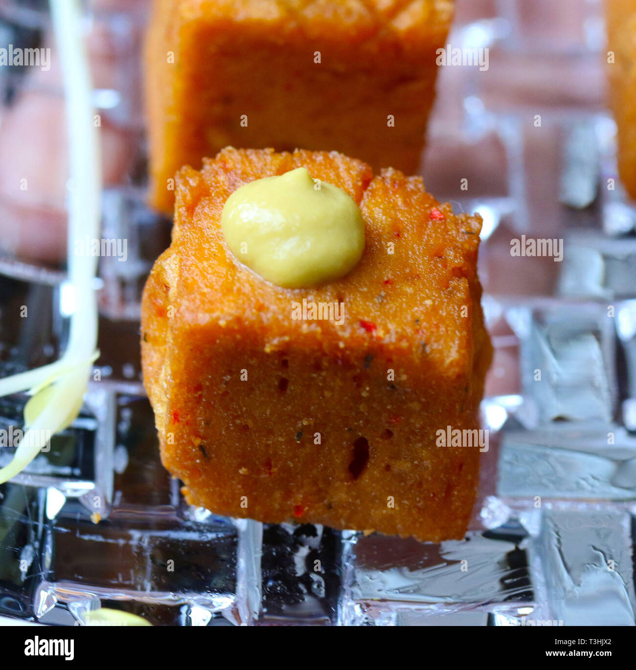Chickpea appetizers with a mustard drop on crystal glass dish Stock ...