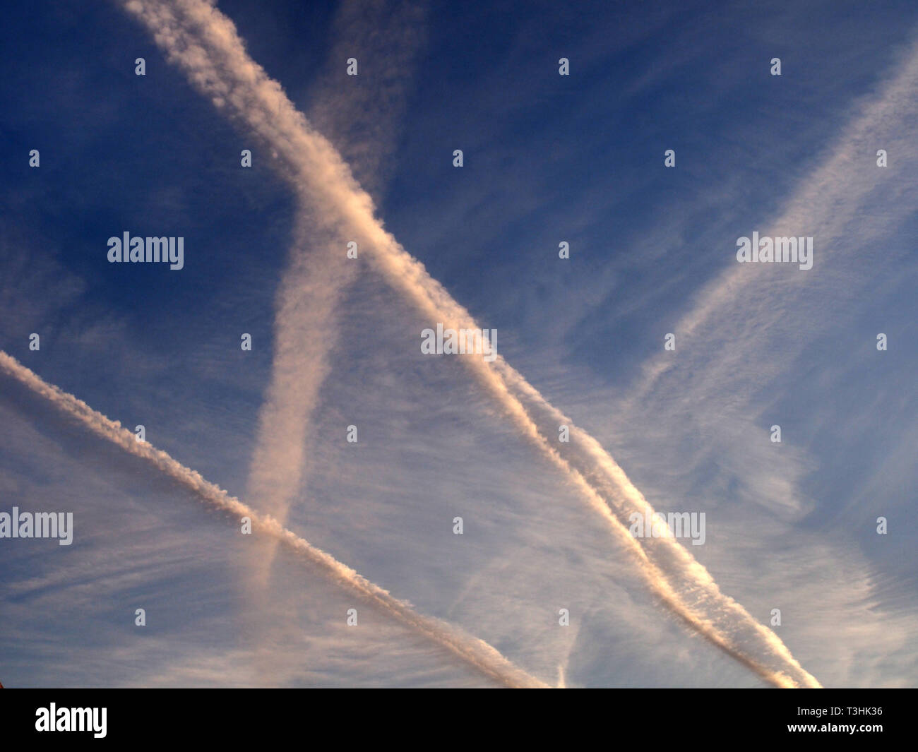 Contrails from a jet plane in the sky. Drawing from the clouds Stock ...