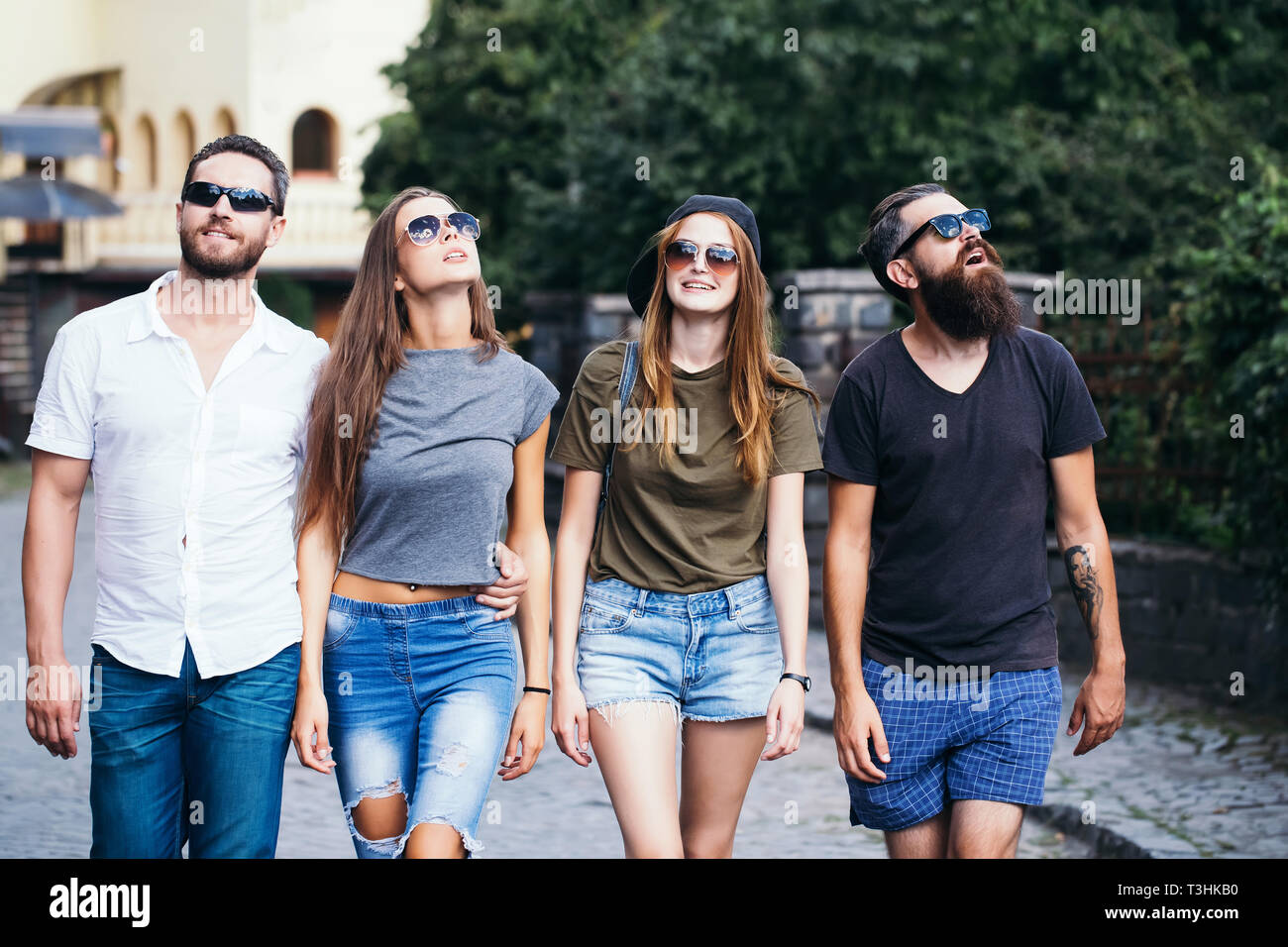 Group of friends walking on streets Stock Photo - Alamy
