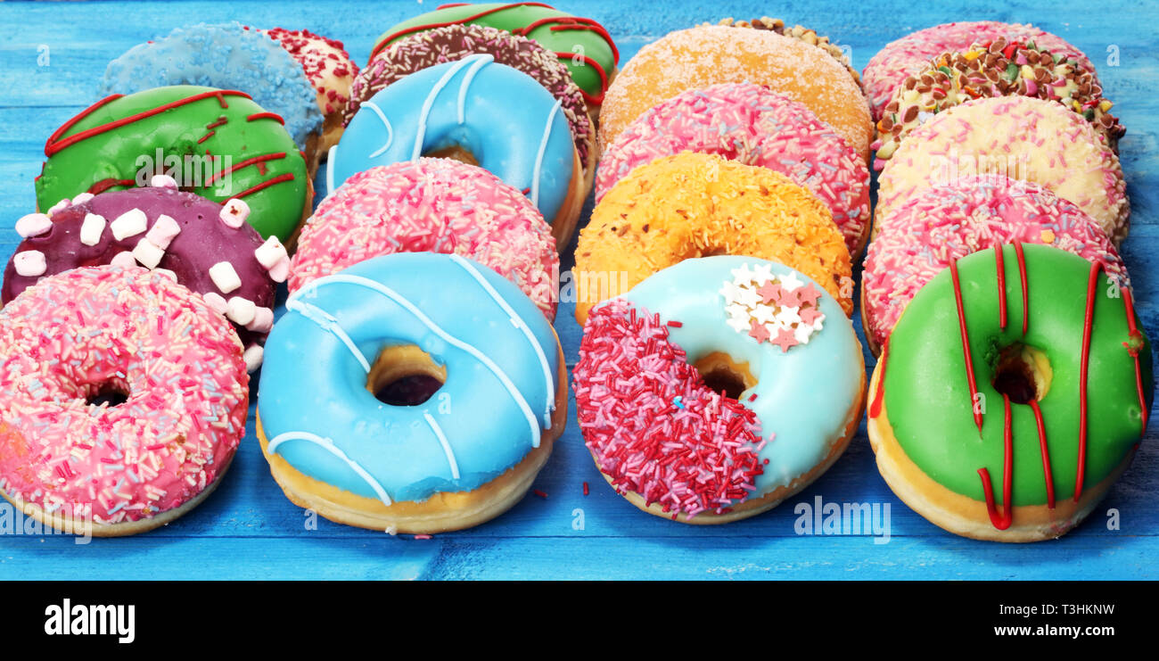 assorted donuts with chocolate frosted, pink glazed and sprinkles ...