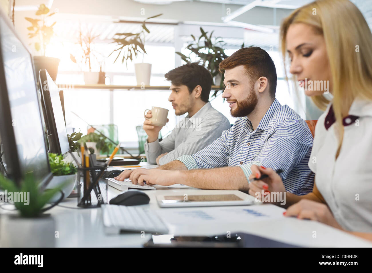Young millennial people working on computers at coworking Stock Photo ...