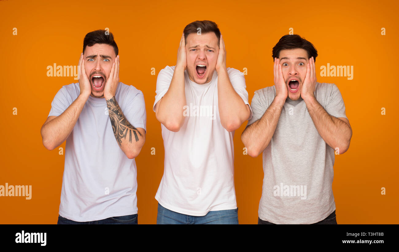 Shocked men with open mouth over orange background Stock Photo - Alamy
