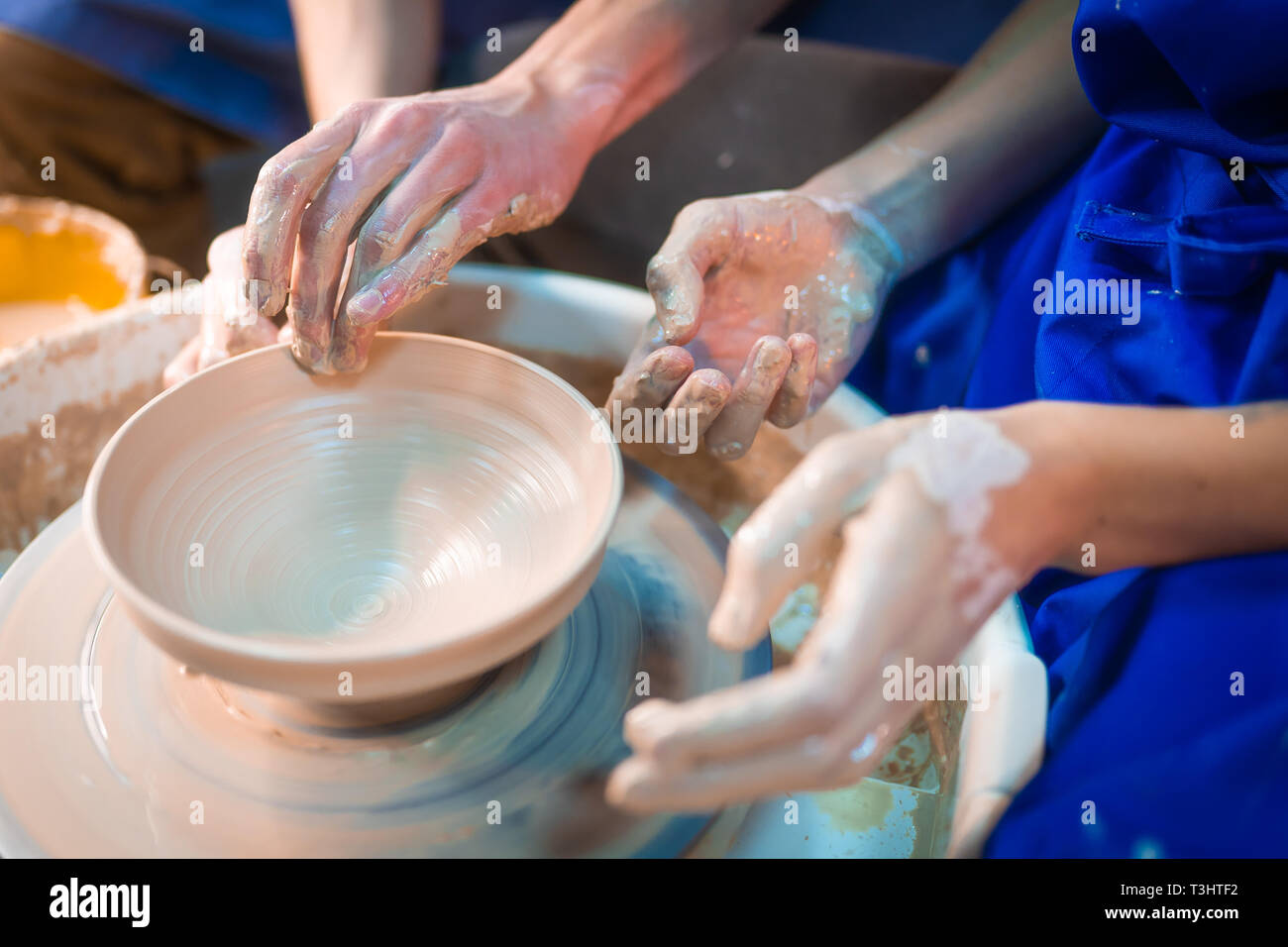 Traditional pottery making, man teacher shows the basics of pottery in ...