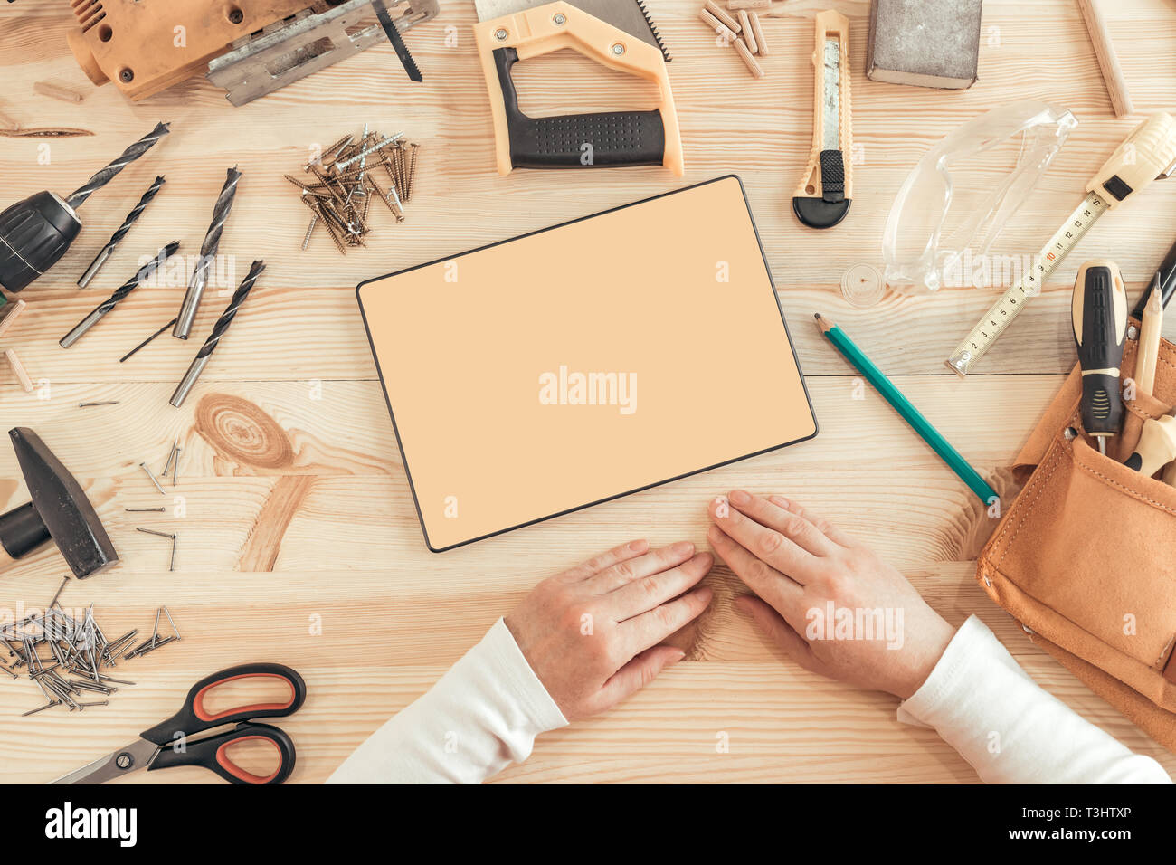 Female carpenter using digital tablet computer in woodwork workshop ...