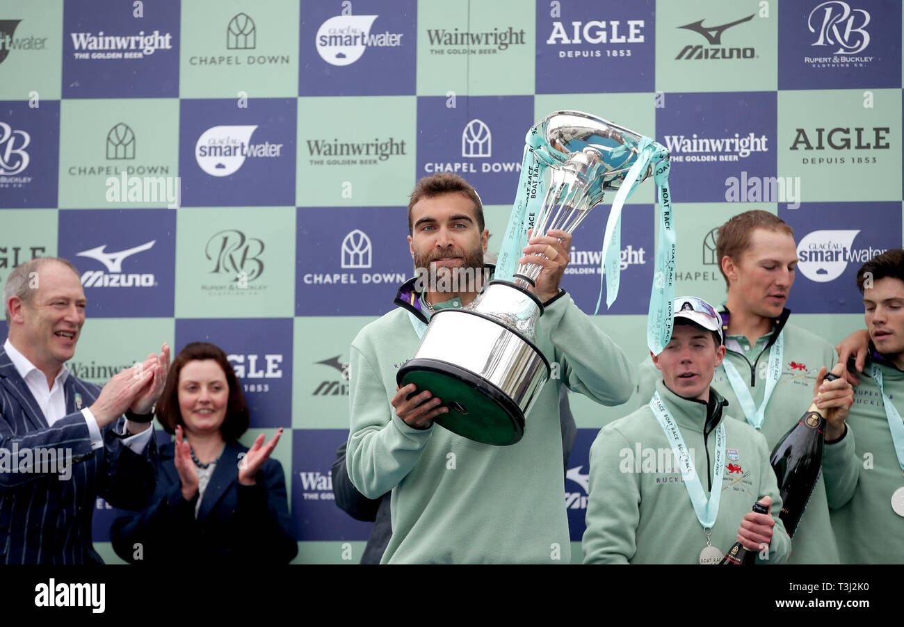 Cambridge president Dara Alizadeh lifts the trophy during the Men's ...