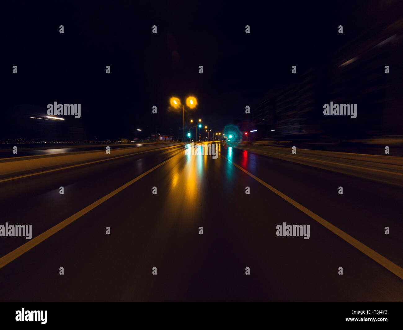 Road from drivers angle at night with green lights Stock Photo - Alamy