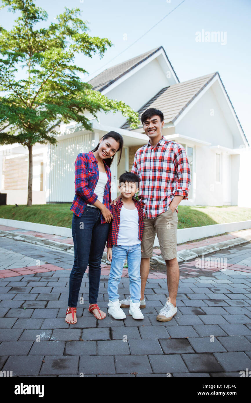 asian family standing in front of their new house together Stock Photo ...