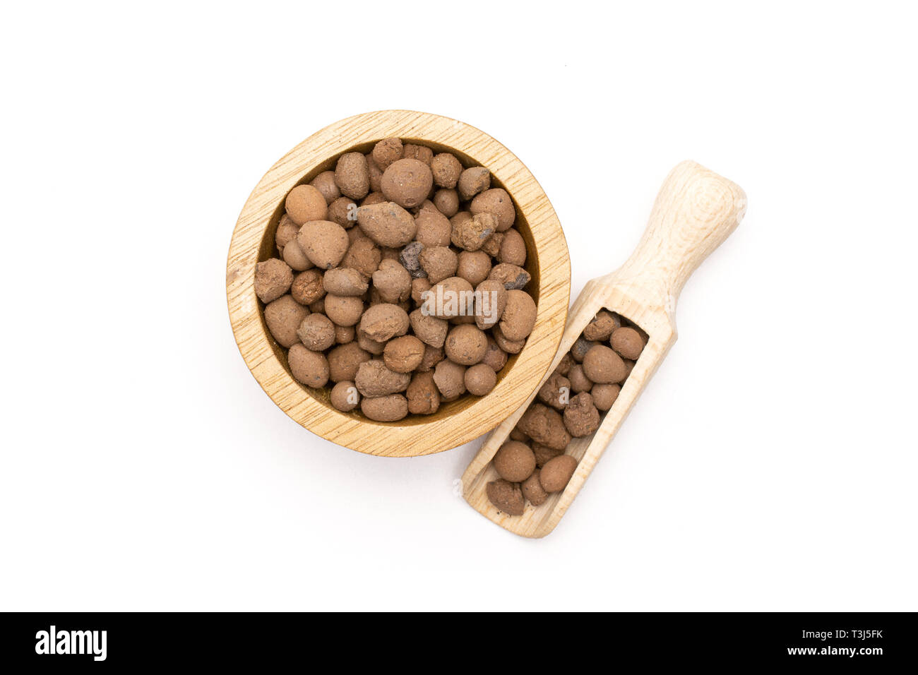 Lot of whole brown clay pebbles (leca) with wooden bowl and wooden ...