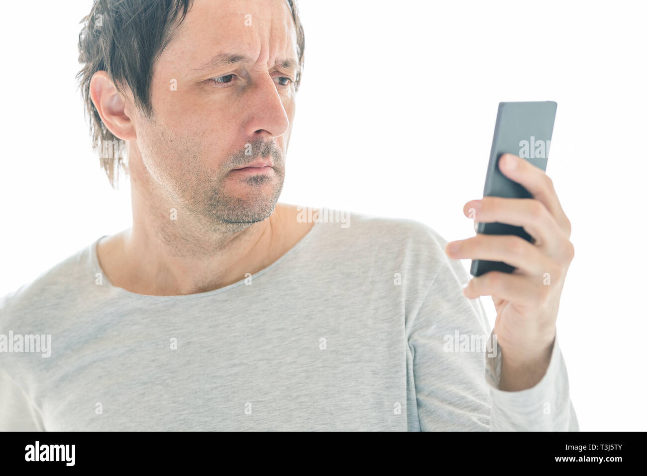 Handsome man using mobile phone isolated on white background. Adult ...