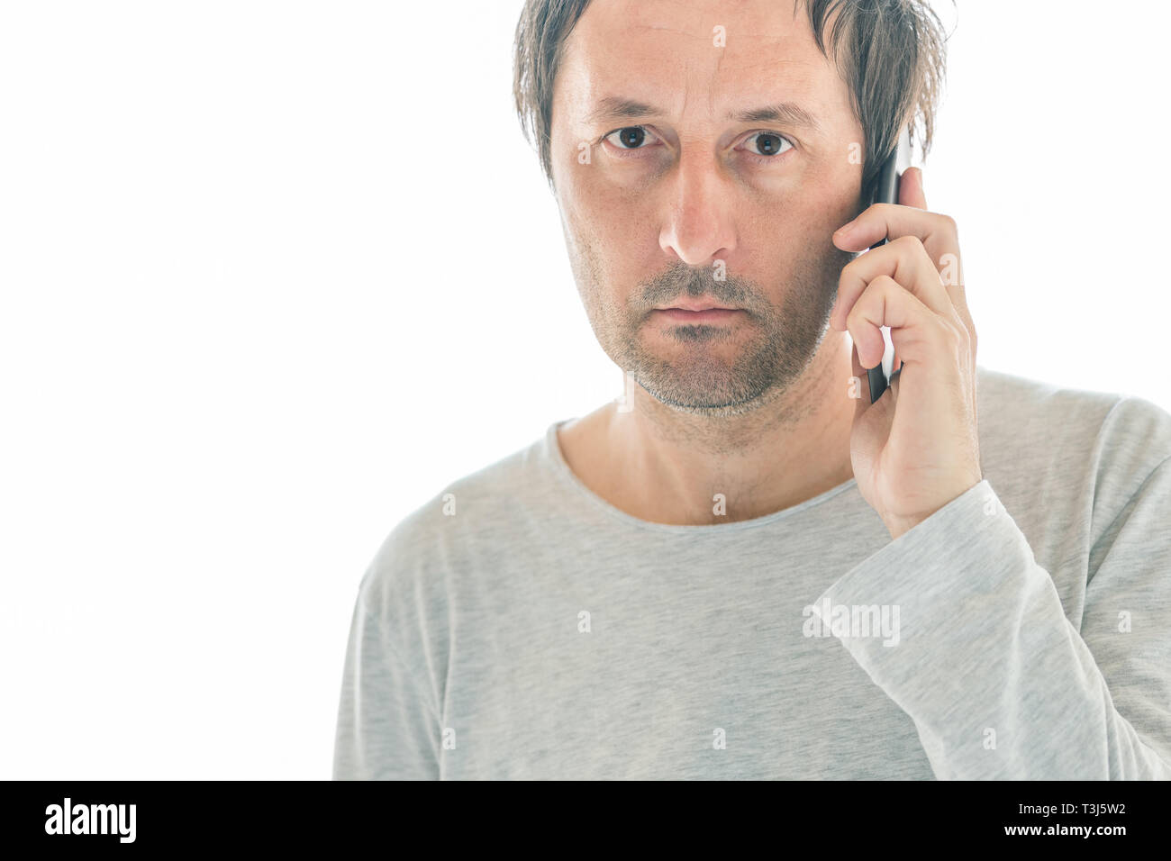 Handsome man using mobile phone isolated on white background. Adult ...