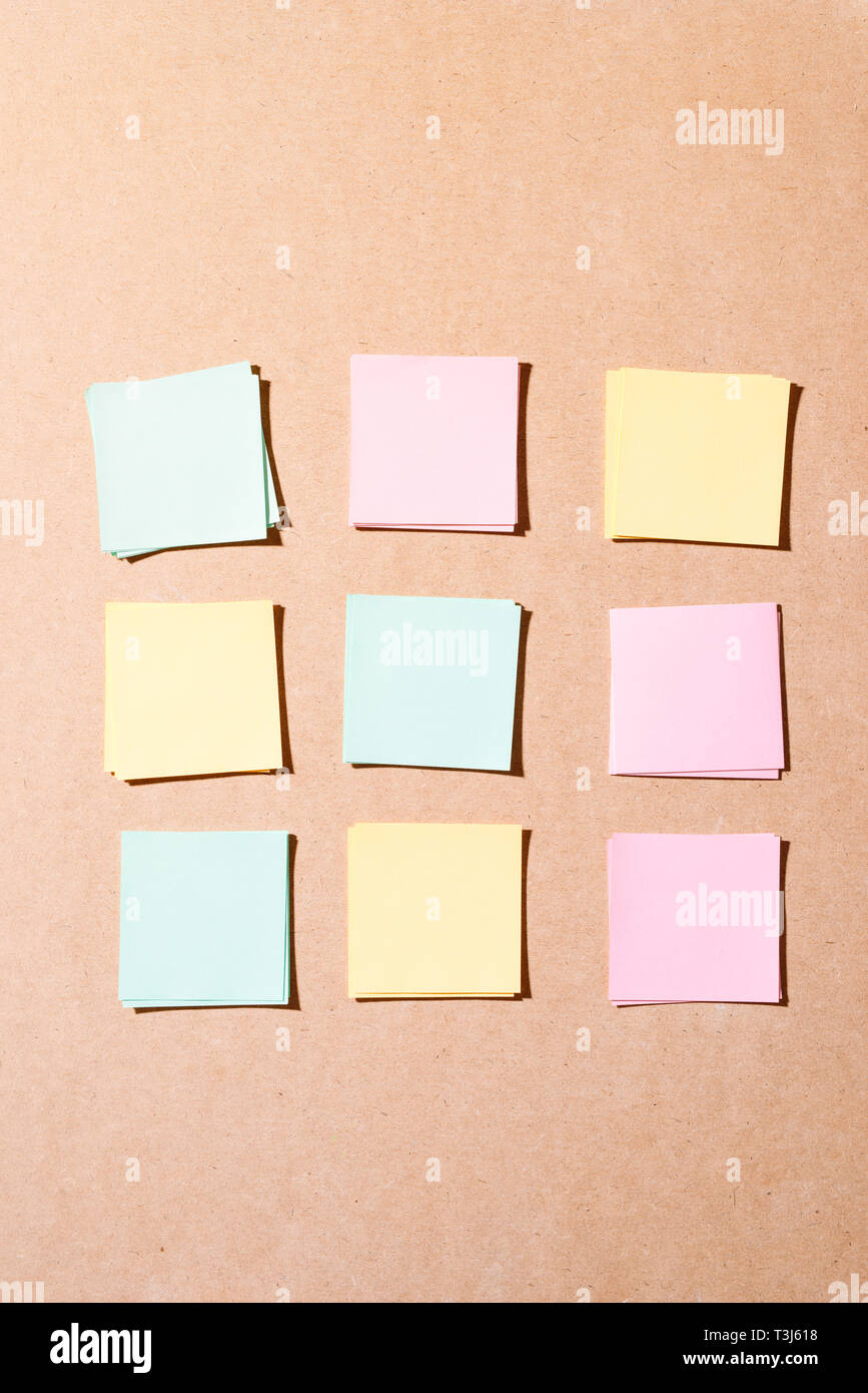 Multi colored notepads laying on a wooden plank board surface with copy ...