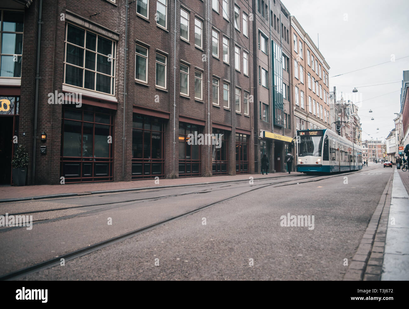 Modern public transport in Amsterdam, Netherlands. White and blue tram ...