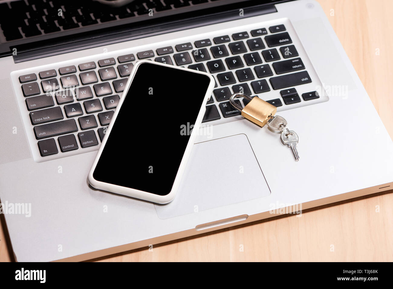 Smartphone and padlock is lying on a laptop keyboard Stock Photo - Alamy
