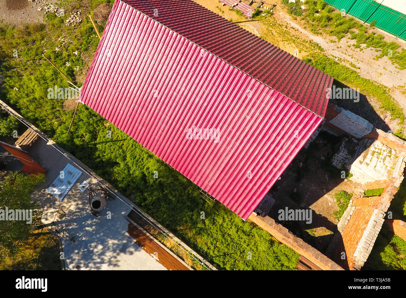 A house with a red roof made of corrugated metal sheets. Roof from ...