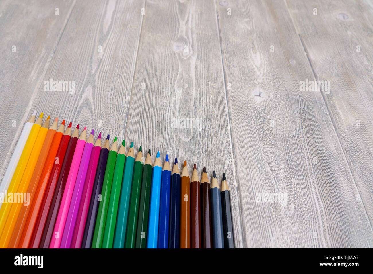collection of rainbow spectrum color crayons on a white-grey vintage ...