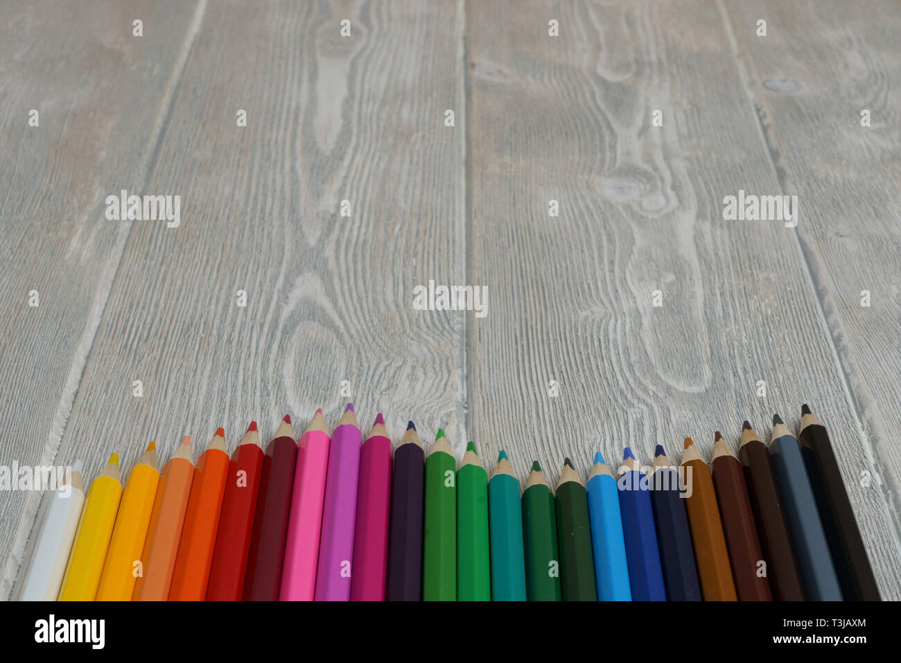collection of rainbow spectrum color crayons on a white-grey vintage ...