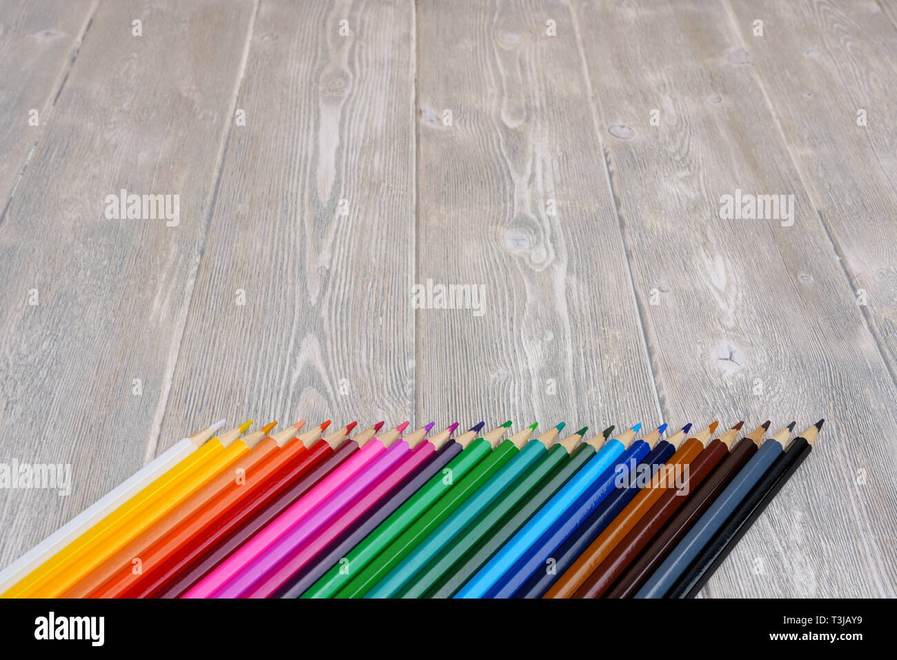 collection of rainbow spectrum color crayons on a white-grey vintage ...