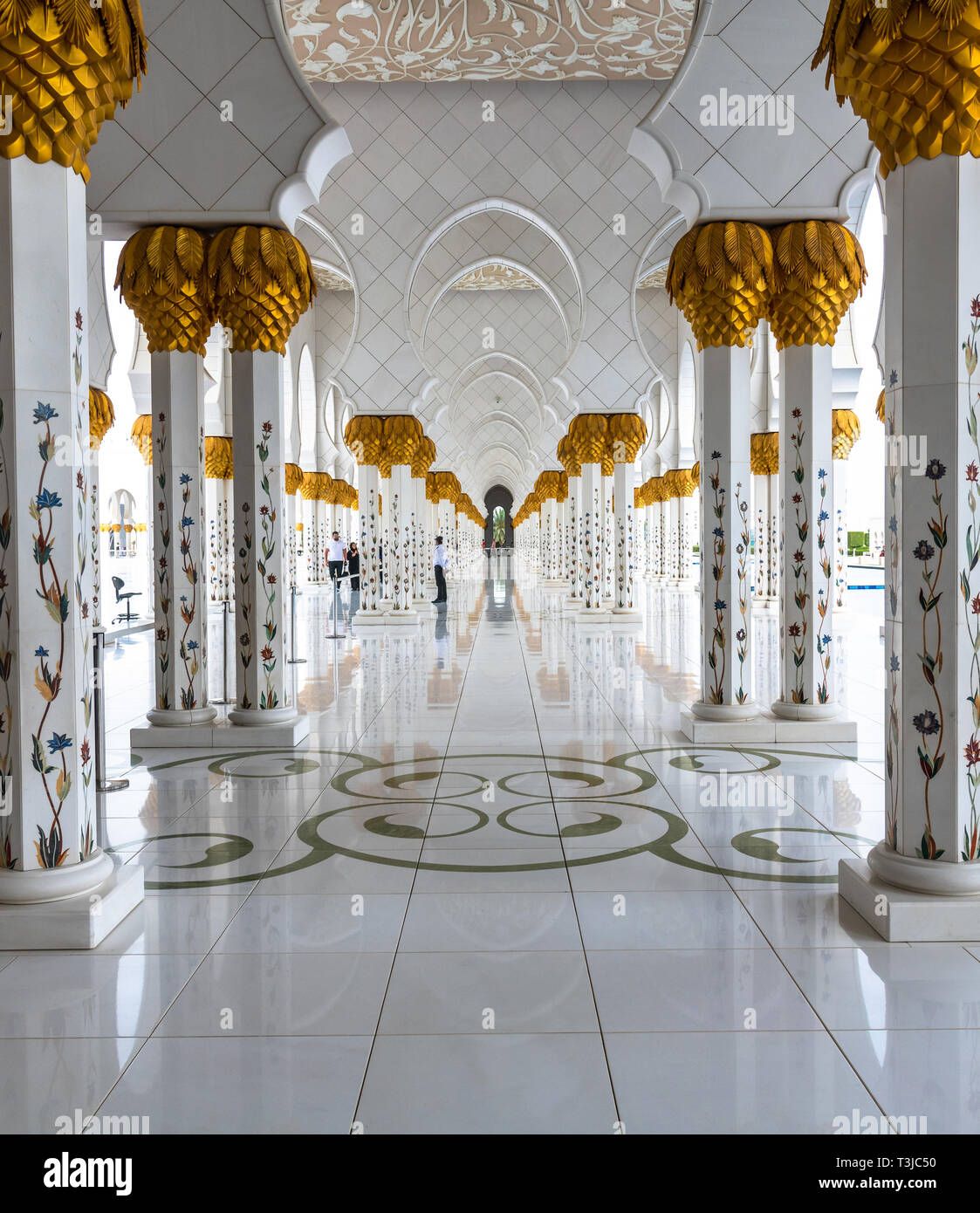 Abu Dhabi, UAE - March 31. 2019. People in Colonnade with floral ...
