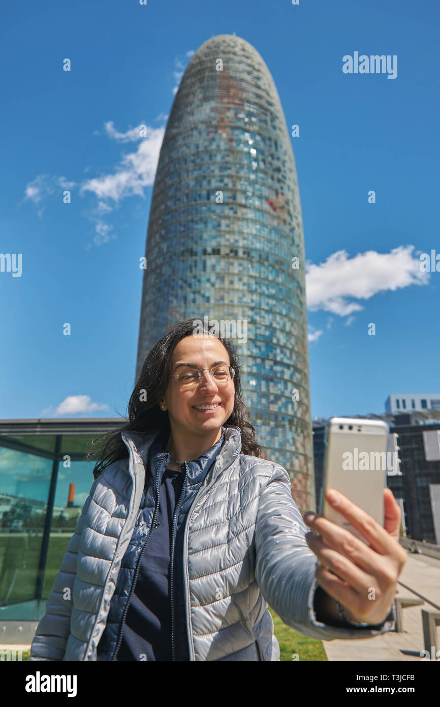 Pretty hispanic woman with mobile make self-portrait in a sunny day in ...