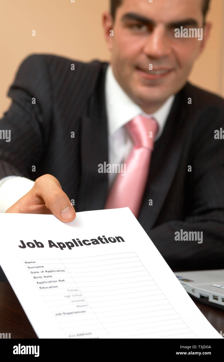young happy businessman giving a job application form Stock Photo - Alamy