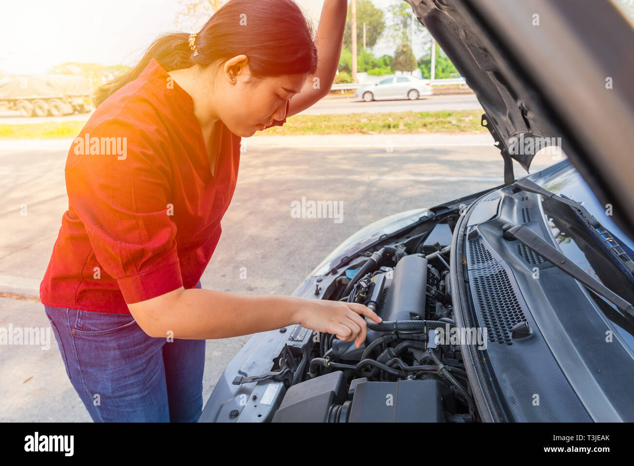 Asian teen girl open car hood to checking engine oil fix breakdown ...