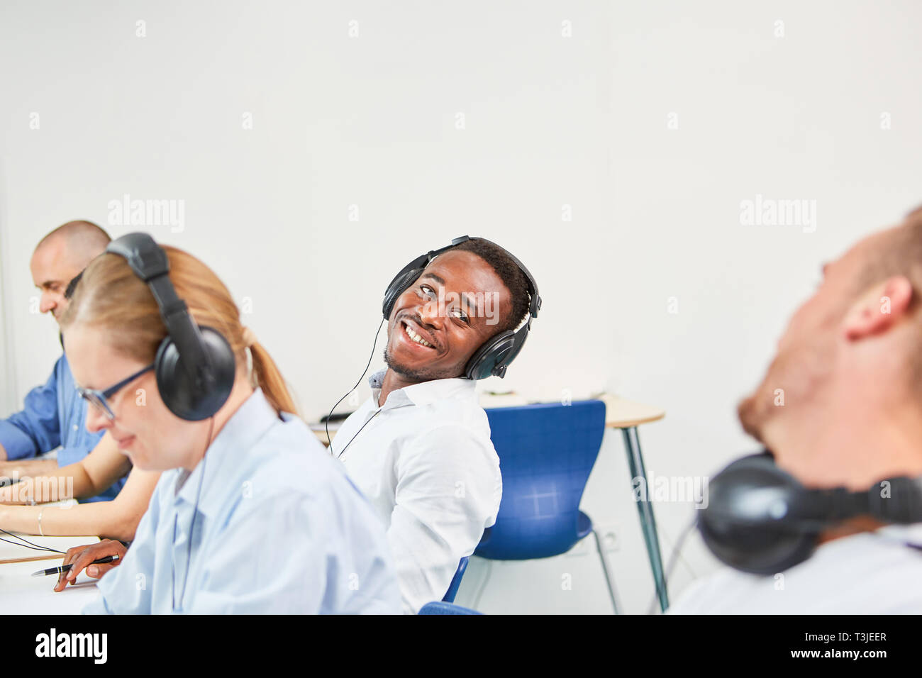 Students or business colleagues have fun together in the language ...