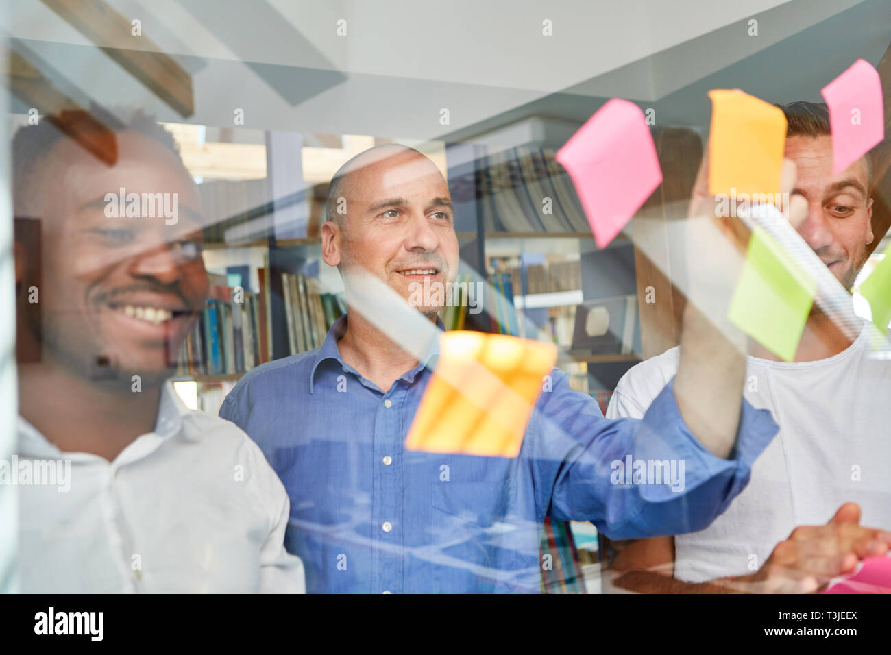 Creative business team collects project ideas on sticky notes in ...