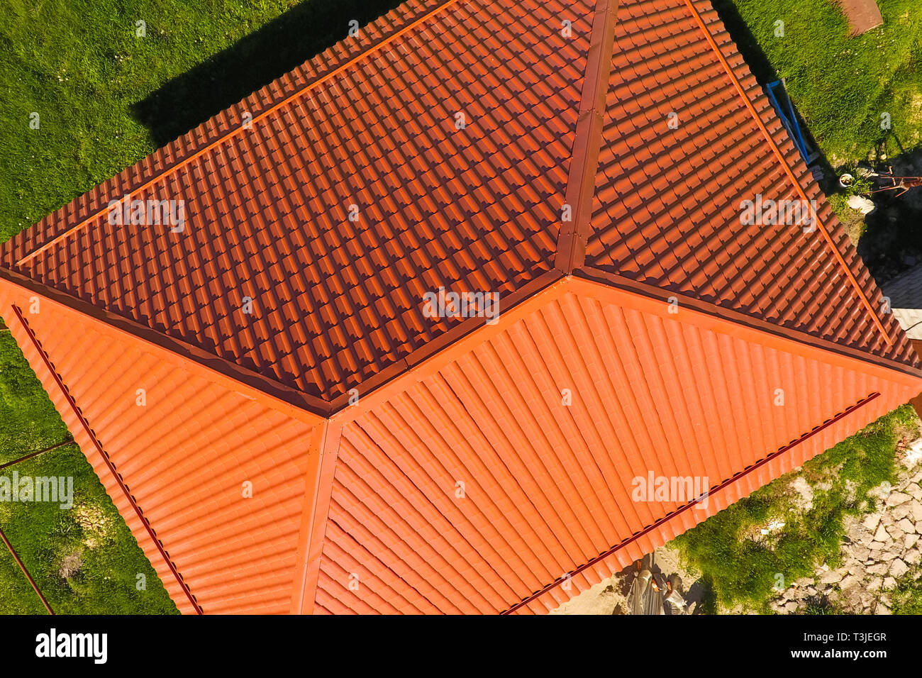 House with an orange roof made of metal, top view. Metallic profile ...